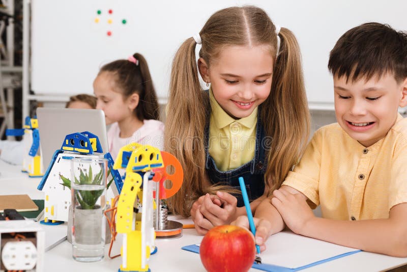 Smart Pupils Working on New Robotics Project, Making Notes Stock Photo ...