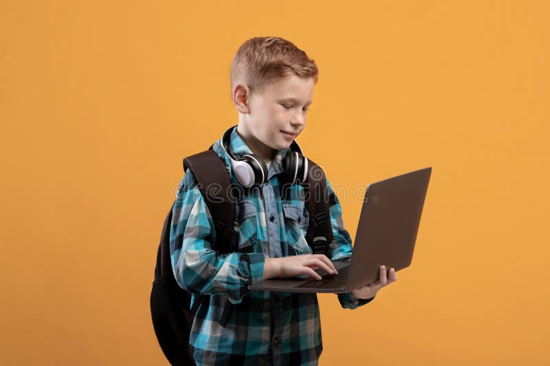 Smart Schoolboy with Backpack and Headset Holding Laptop Stock Image ...