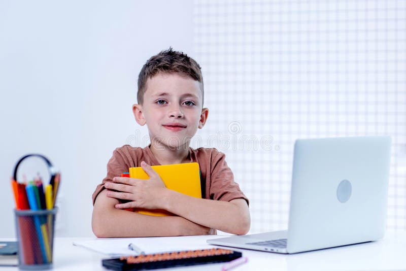 Smart Schoolboy is Ready To Study at a Neat Table in a White Interior ...