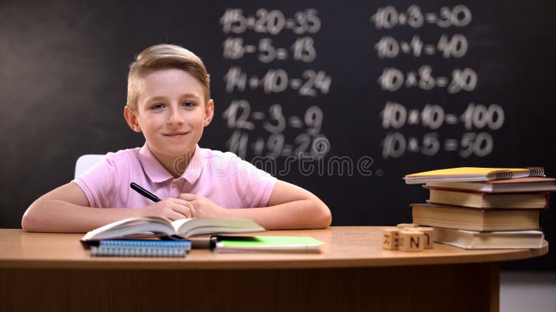 Smart Schoolboy Smiling To Camera after Solving Task, Exercises Written ...