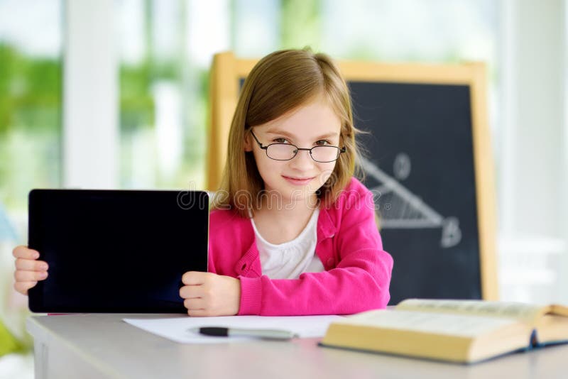 Smart Schoolgirl Doing Her Homework with Digital Tablet at Home. Child ...