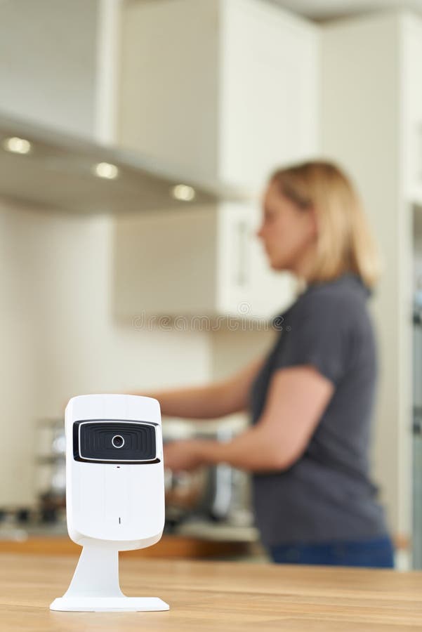 Smart Security Camera in Kitchen As Woman Prepares Meal Stock Photo ...