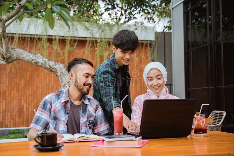 Smart Students Studying Together with a Laptop and Books Stock Photo ...