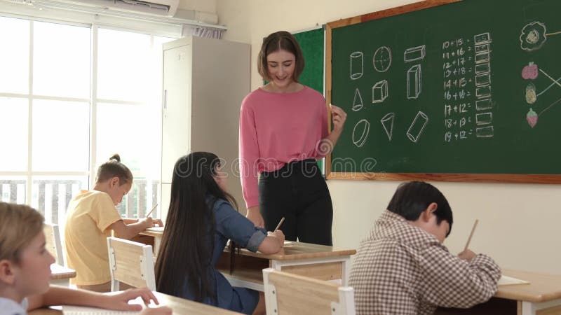 Teacher Checking Cute Student Homework while Explaining Idea at Class ...