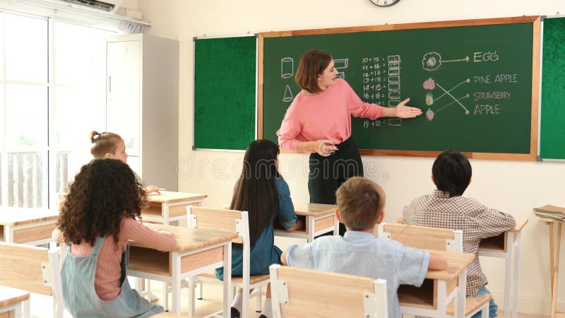 Teacher Checking Cute Student Homework while Explaining Idea at Class ...