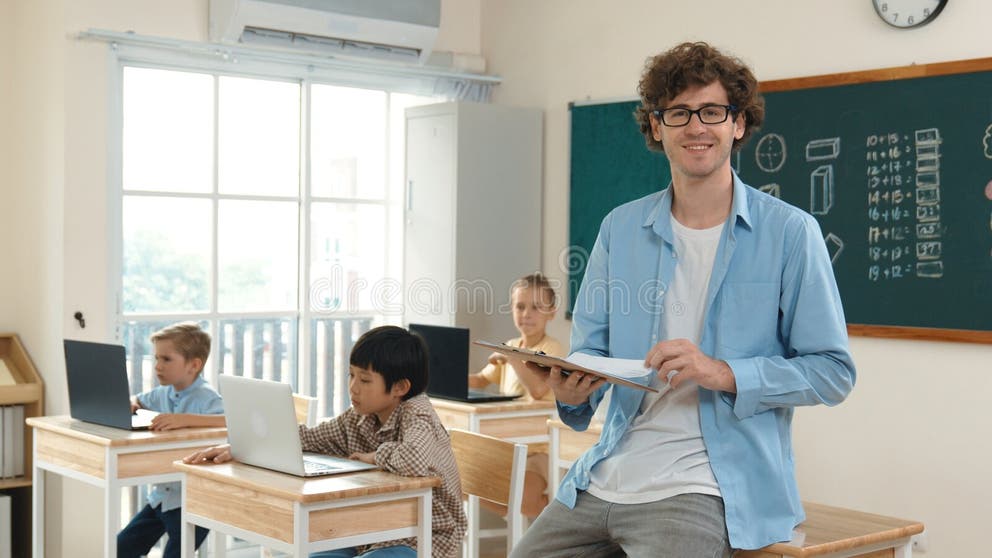 Smart Teacher Checking Document and Looking at Camera at Classroom ...