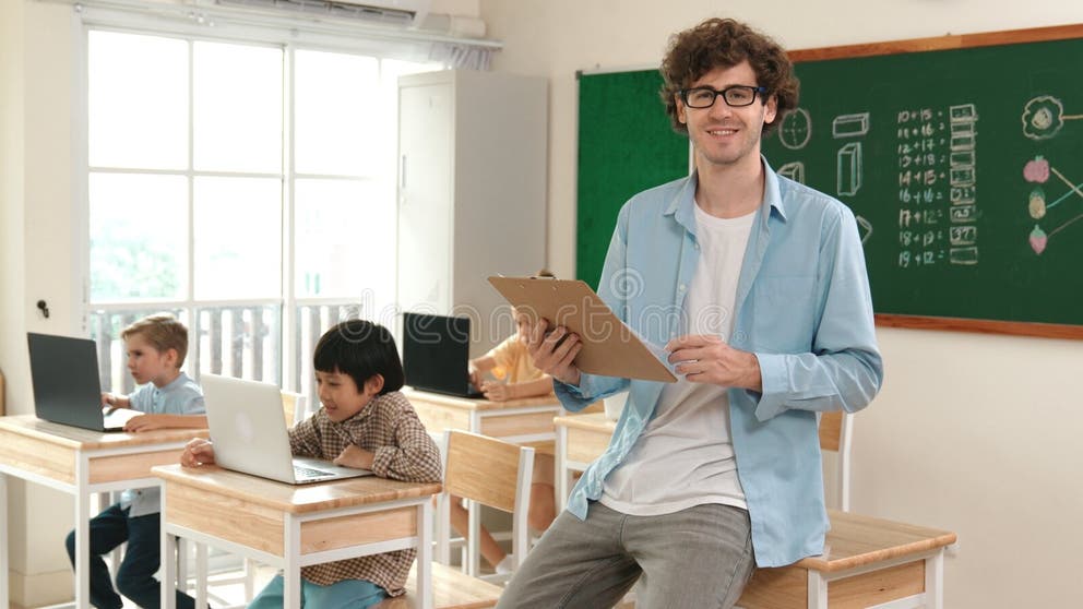 Smart Teacher Checking Document and Looking at Camera at Classroom ...