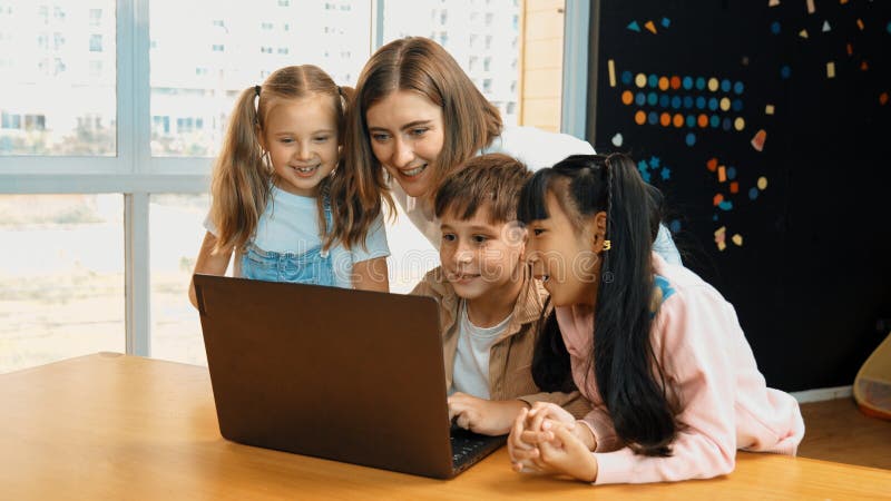Caucasian Teacher Checking Student Answer while Learner Using Laptop ...