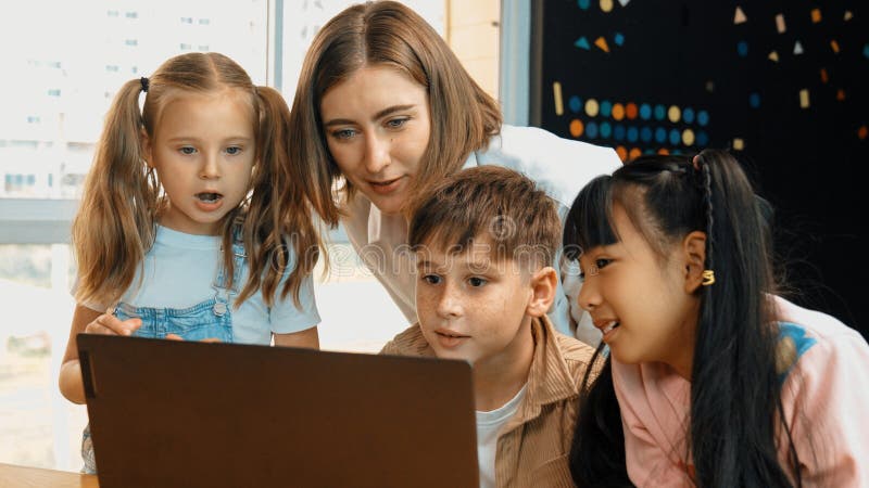 Caucasian Teacher Checking Student Answer while Learner Using Laptop ...