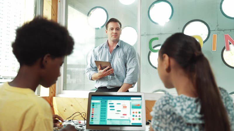 Smart Teacher Hold Tablet while Back View Student Learning Code. Edification Stock Video - Video ...