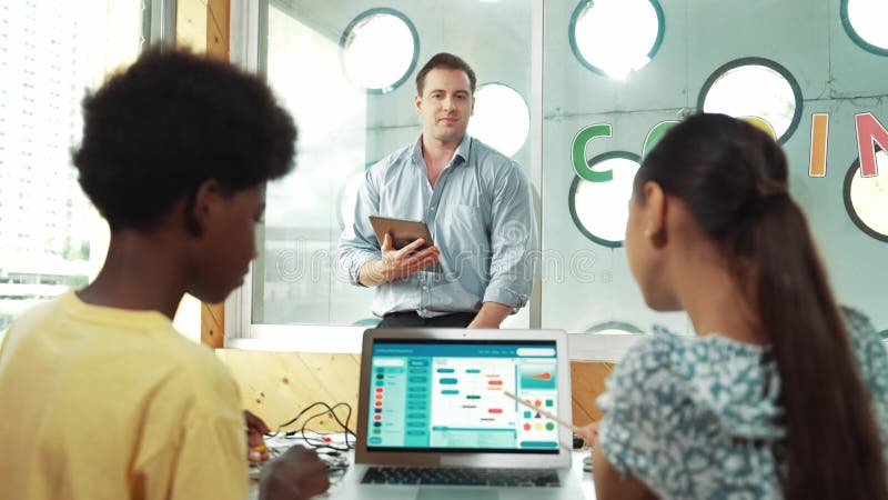 Smart Teacher Hold Tablet while Back View Student Learning Code. Edification Stock Video - Video ...