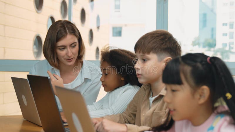 Smart Teacher Teaching and Looking Student Using Laptop at Classroom ...