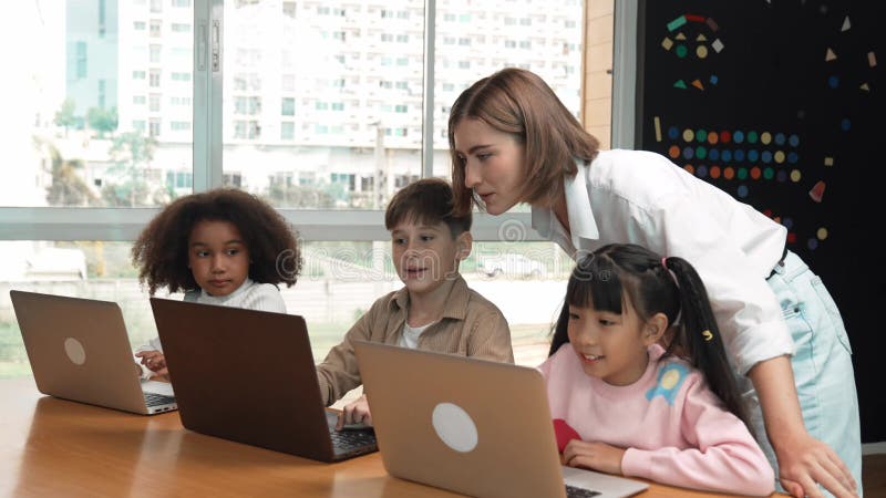 Smart Teacher Teaching and Looking Student Using Laptop at Classroom ...