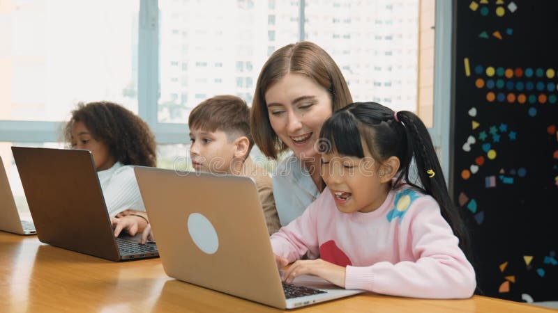 Smart Teacher Teaching and Looking Student Using Laptop at Classroom ...