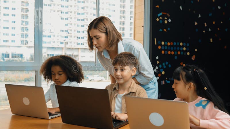 Smart Teacher Teaching and Looking Student Using Laptop at Classroom ...