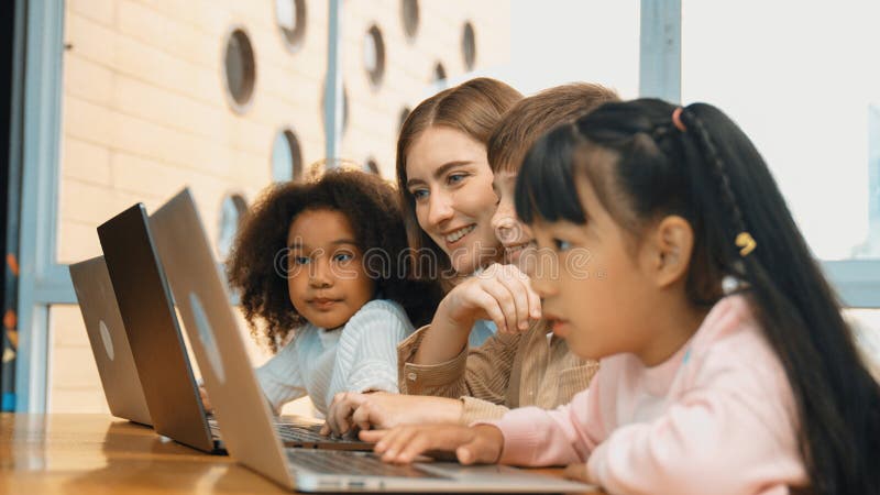 Smart Teacher Teaching and Looking Student Using Laptop at Classroom ...