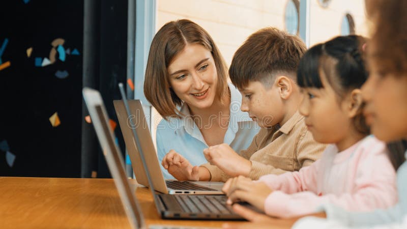 Smart Teacher Teaching and Looking Student Using Laptop at Classroom ...