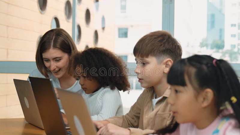 Smart Teacher Teaching and Looking Student Using Laptop at Classroom ...