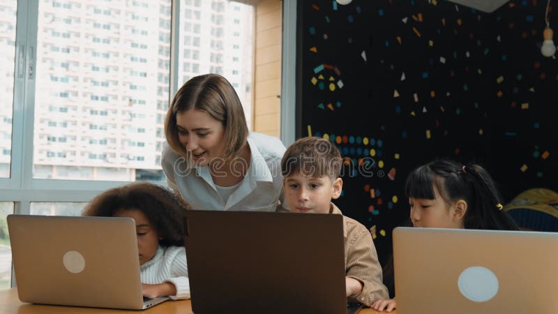 Smart Teacher Teaching and Looking Student Using Laptop at Classroom ...