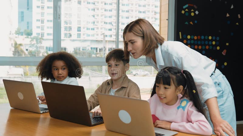 Smart Teacher Teaching and Looking Student Using Laptop at Classroom ...