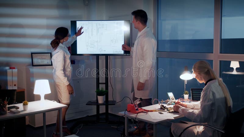 Smart Team of Electronics Development Engineers Discussing Something on ...