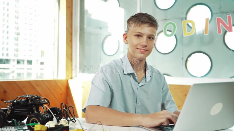 Teenager Working on Laptop and Looking at Camera at STEM Class ...