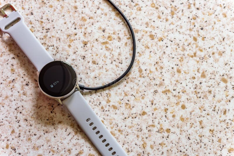 Smart Watch Wireless Charging on Charging Pad on Kitchen Worktop Table ...