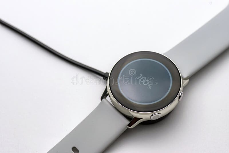 Smart Watch Wireless Charging on Charging Pad on Kitchen Worktop Table ...