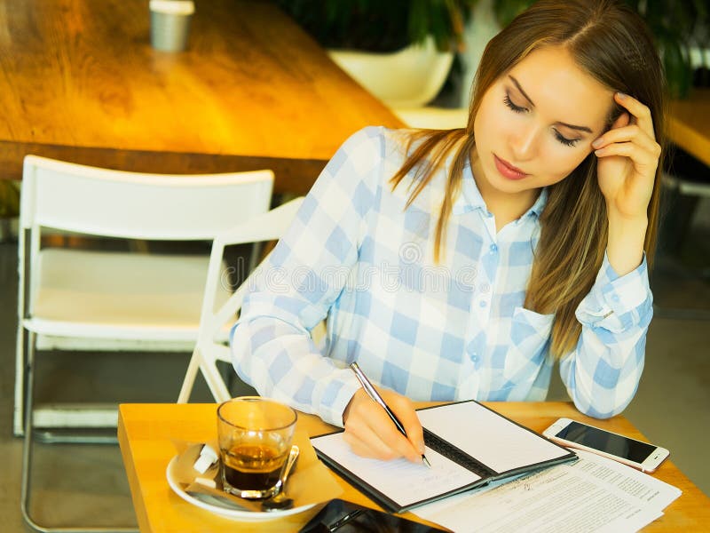 Smart Woman Writing Down Her Ideas and Drinking Coffe in Cafe Stock ...