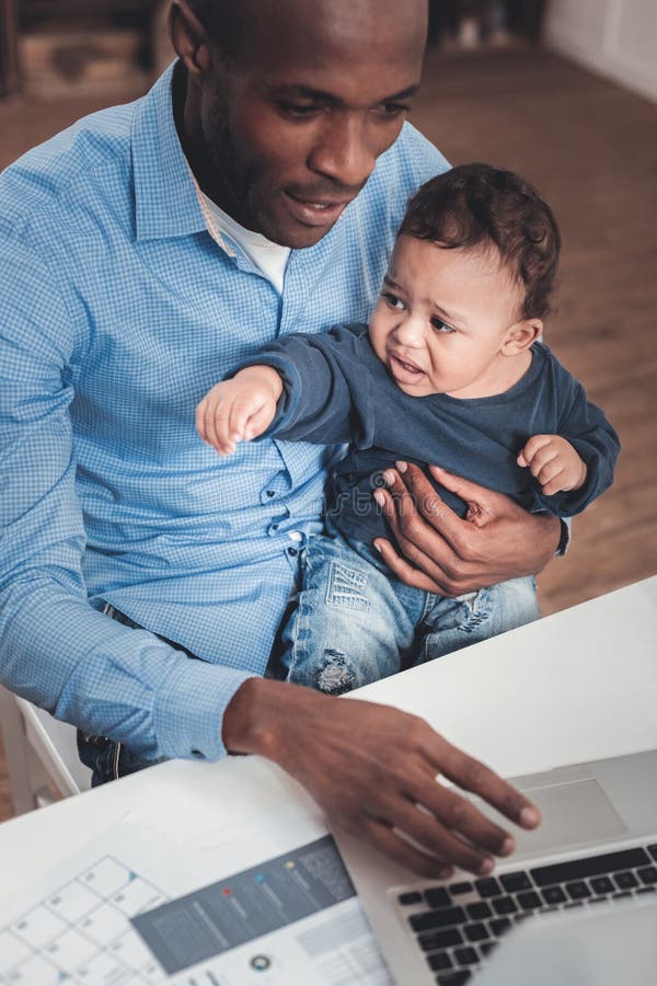 Smart young father working stock image. Image of fatherhood - 133597567