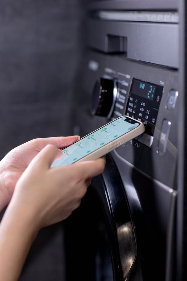 Smartphone with App Used To Control Washing Machines Stock Photo ...