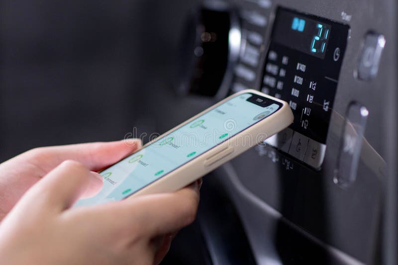 Smartphone with App Used To Control Washing Machines Stock Photo ...