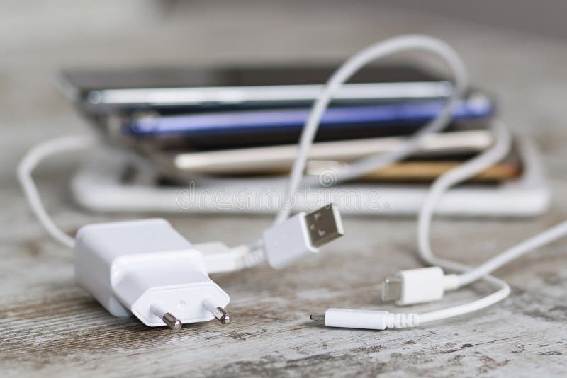 Smartphones pile and cable stock photo. Image of connection - 252566040