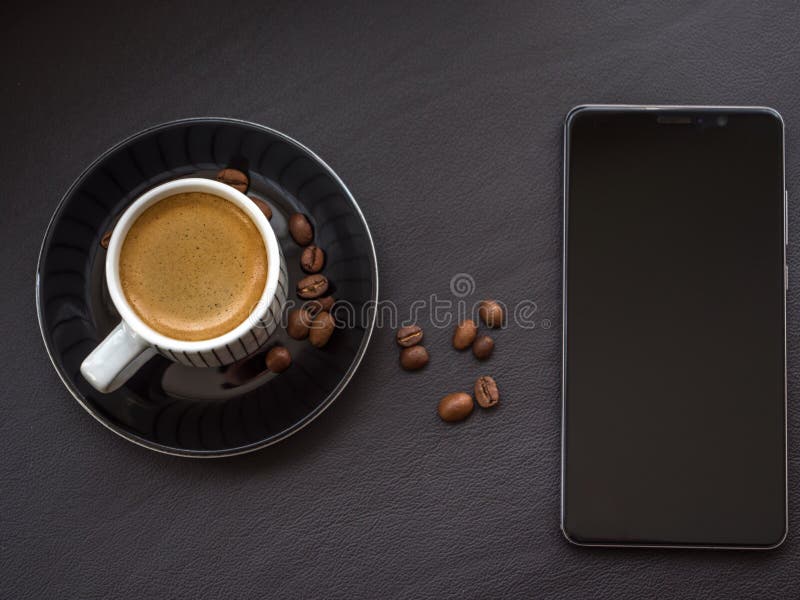 Smartphone Besides Coffee On Dark Leather Surface Stock Photo - Image ...