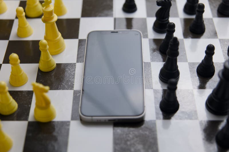 Smartphone with Black and White Chess Pieces on a Chessboard Stock ...