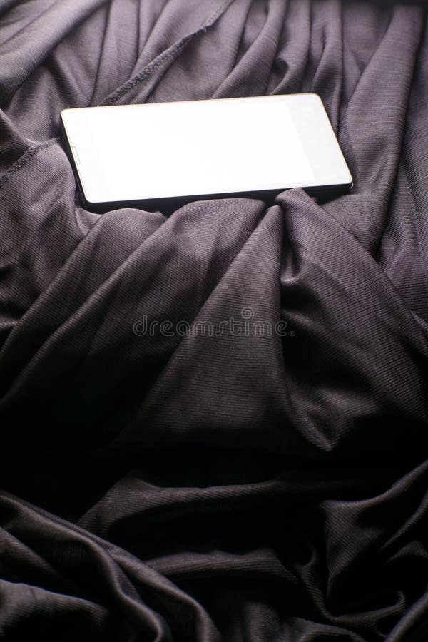 Smartphone with Blank White Display for Mockups on a Folded Satin Black ...
