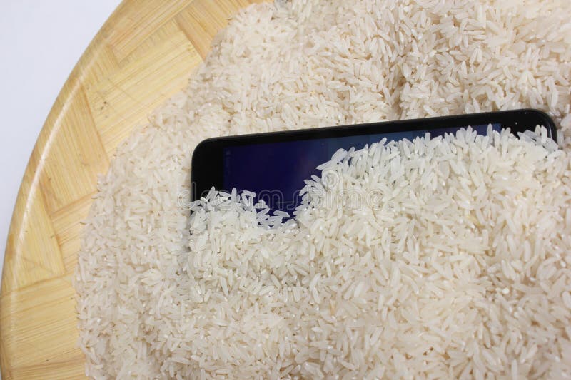 Smartphone in Bowl of White Rice To Remove Water from Phone Stock Photo ...