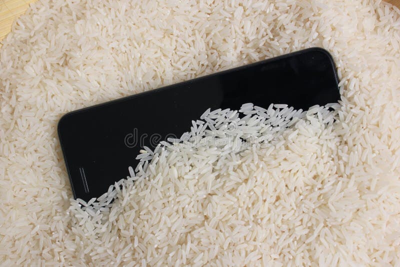 Smartphone in Bowl of White Rice To Remove Water from Phone Stock Photo ...