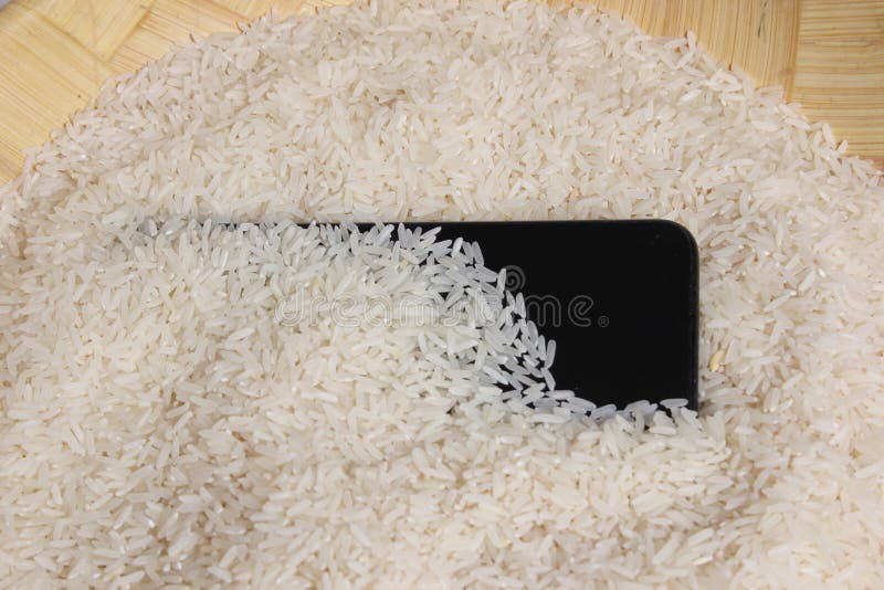Smartphone in Bowl of White Rice To Remove Water from Phone Stock Photo ...