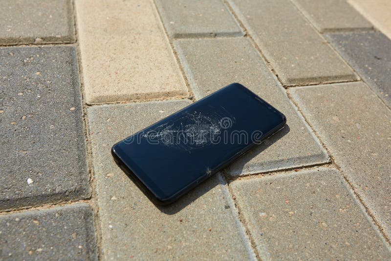 Smartphone with a Broken Screen on Pavement. Mobile Phone Fell and ...