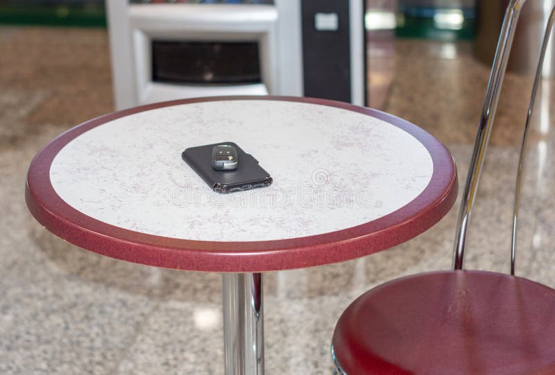 Smartphone and a Car Key on a Round Table Under the Lights Stock Photo ...