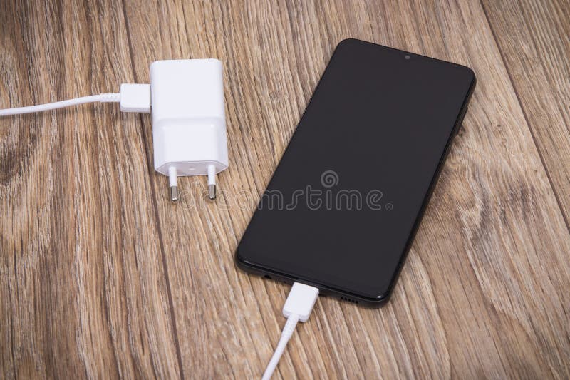 Smartphone and Charger Using To Charge Empty Battery. Various Devices ...