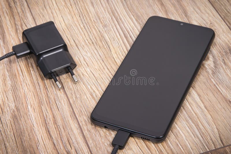 Smartphone and Charger Using To Charge Empty Battery. Various Devices ...