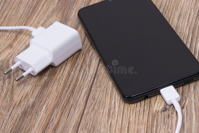 Smartphone and Charger Using To Charge Empty Battery. Various Devices ...