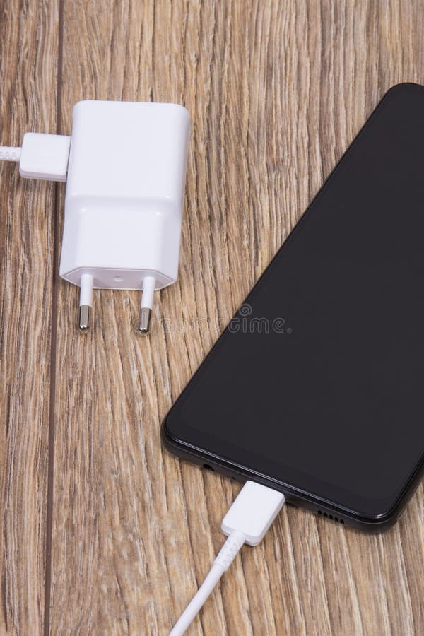 Smartphone and Charger Using To Charge Empty Battery. Various Devices ...