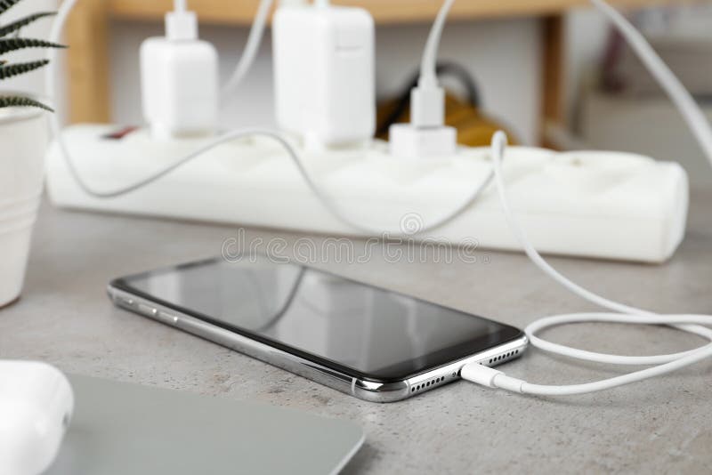 Smartphone Charging with Cable on Stone Table Stock Photo - Image of ...