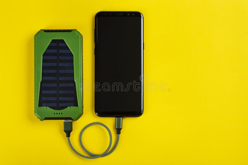 Smartphone Charging with Power Bank on Yellow Background Stock Image ...