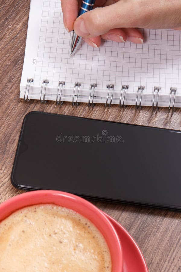 Smartphone, Coffee with Milk and Hand of Woman Writing Notes in Notepad ...