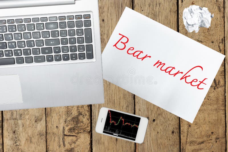 Smartphone, Computer and Paper with Bear Market on Wood Table Stock ...