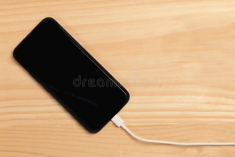 Smartphone with Connected Wire on a Plank Light Surface Stock Photo ...
